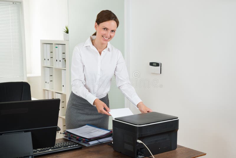Secretary Inserting Paper in Printer Stock Photo - Image of copier ...