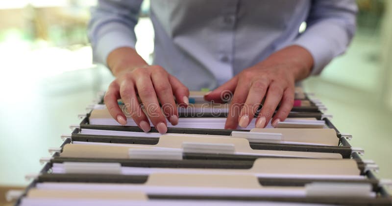 Secretary is Looking in Archive for Folder with Accounting Documents ...