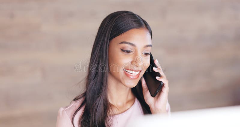 Secretary Talking on a Phone while Working on a Computer at a Front ...