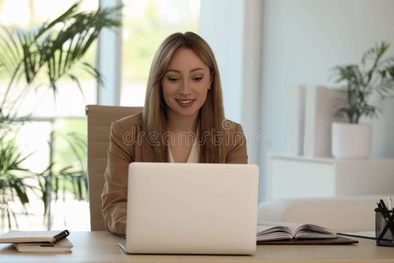 Secretary Working with Laptop at Wooden Table in Office Stock Photo ...