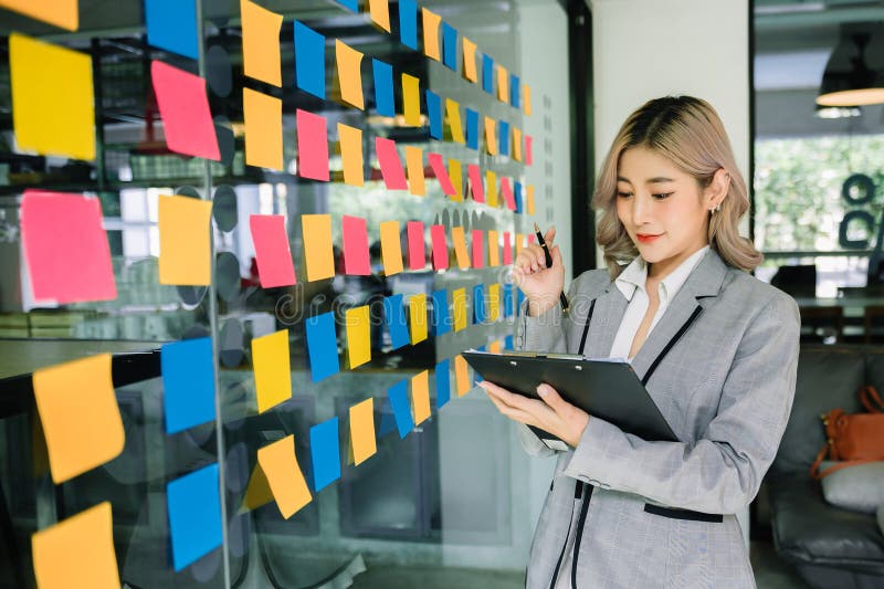 Secretary Working in Modern Office in Skyscraper, Writing and Sticking ...