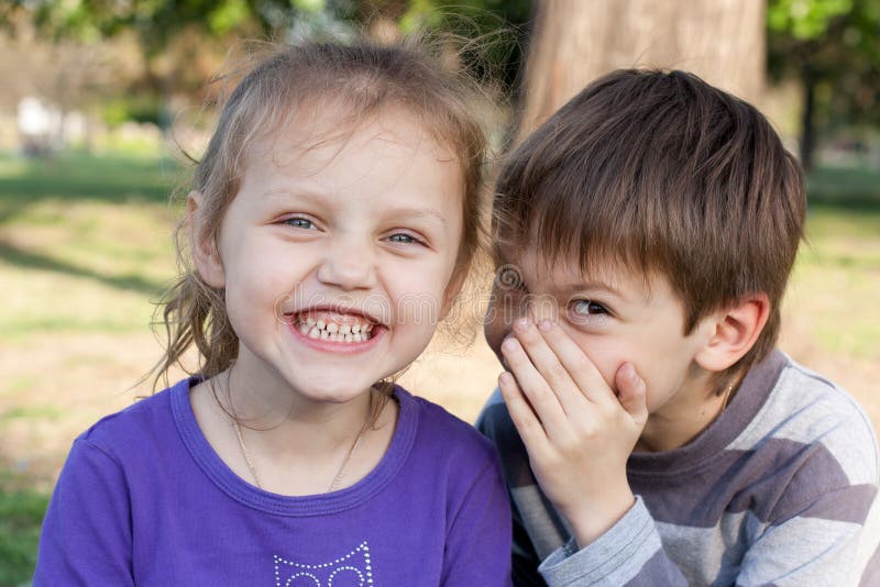 Two Kids Sharing a Secret Outdoors Stock Photo - Image of friends ...