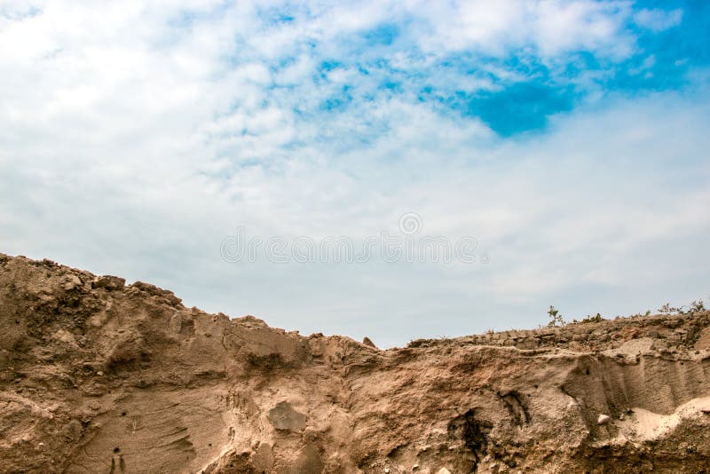 A Section of a Sand Dump Quarry Sand Dunes Sand Stones Sky with Clouds ...