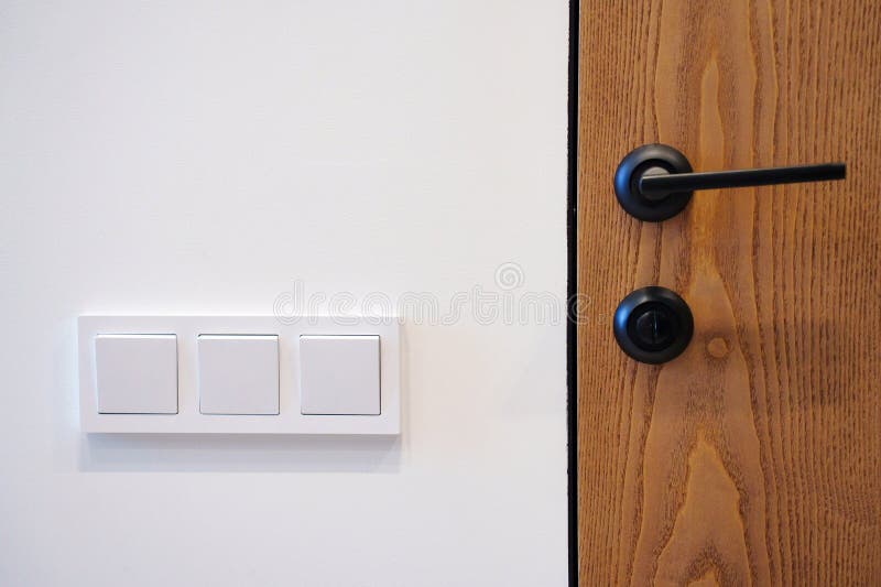 A Section of a Wall Featuring Three White Light Switches Next To a ...