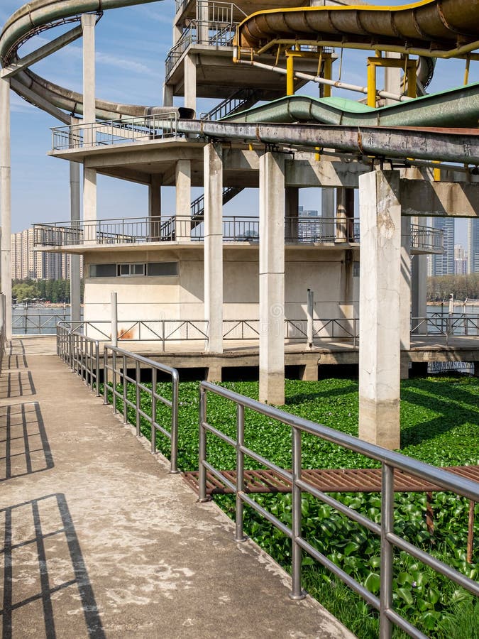 Elevated Tubular Water Slides on Concrete Pillars with Urban Backdrop ...
