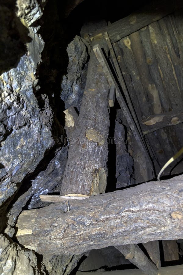 Sections of Timber Hold a Wood Platform Up between the Rocks in a Mine ...