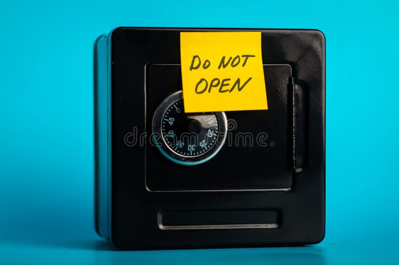 Secure Black Safe with Combination Lock and Caution Note Over a Vibrant ...