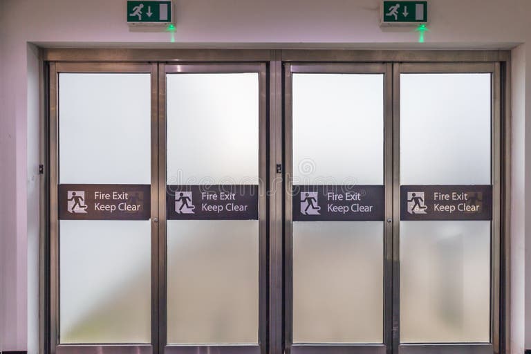 Push Bar Exit Doors with Emergency Signage in Public Building Interior ...