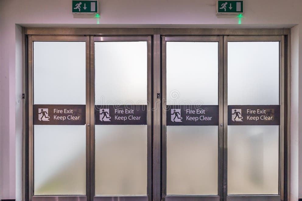 Push Bar Exit Doors with Emergency Signage in Public Building Interior ...