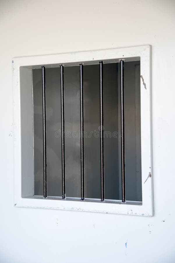 A Secure Window with Bars in a White Door Stock Photo - Image of door ...