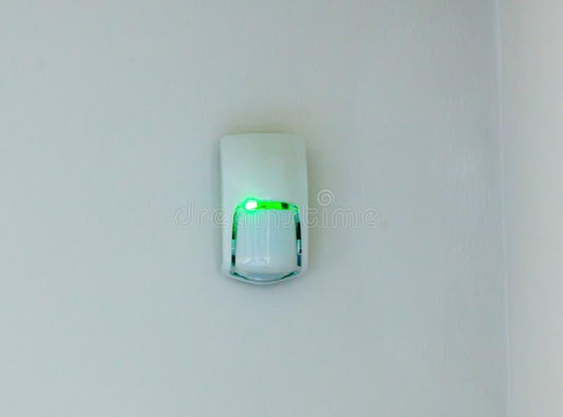 Security Alarm Motion Sensor Flashing Green Light on White Wall Stock ...
