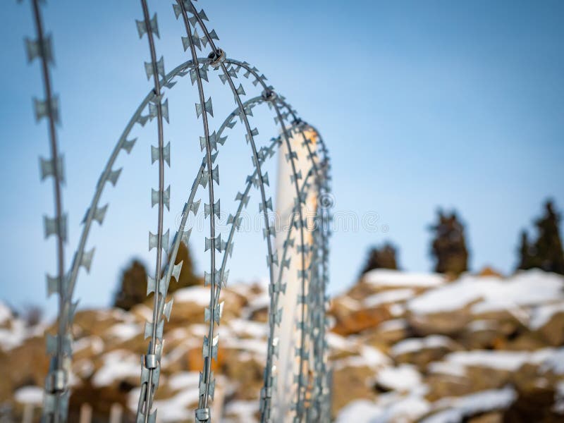 Security Barrier with a Barbed Wire Fence Stock Photo - Image of black ...