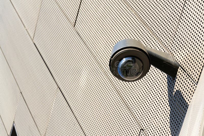 Security Camera Attached To Wall with Windows Background Stock Photo ...