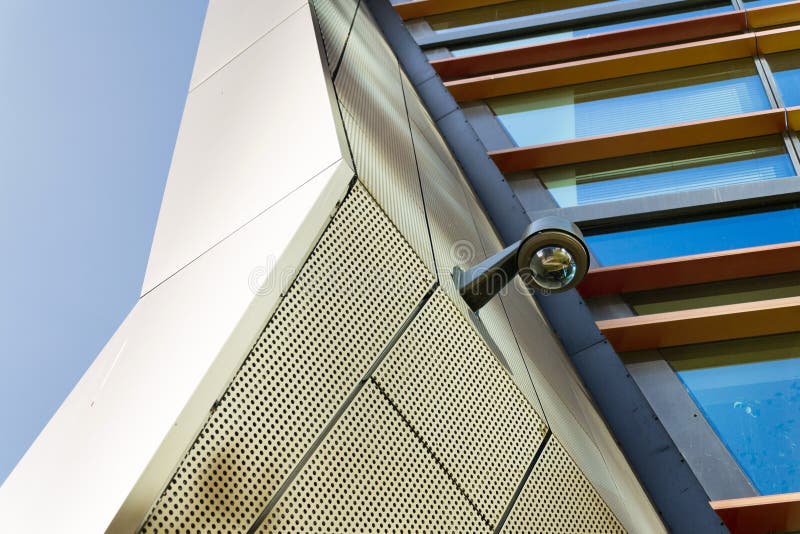 Security Camera Attached To Wall with Windows Background Stock Photo ...