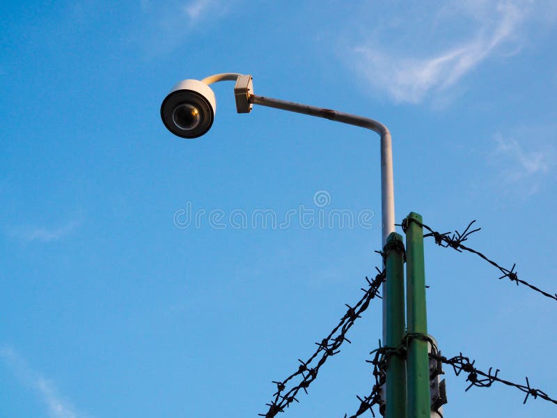 CCTV Security Camera Surveillance System on High Post of Fence Outside ...