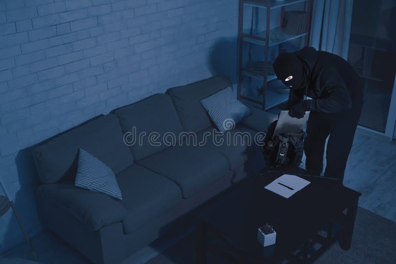Intruder Breaking in an Apartment or Office Stealing Laptop Stock Photo ...