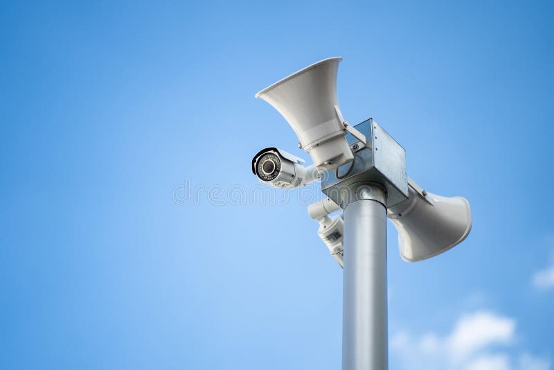Security Camera with Loudspeakers and Megaphone on the Sky Background ...