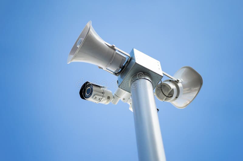 Security Camera with Loudspeakers and Megaphone on the Sky Background ...