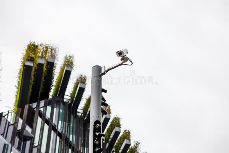 Security Camera on a Metal Post Under a Gloomy Sky Stock Image - Image ...