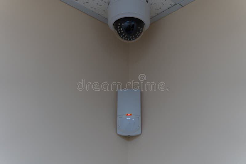Security Camera and Motion Detector Installed on Ceiling in Room. Stock ...