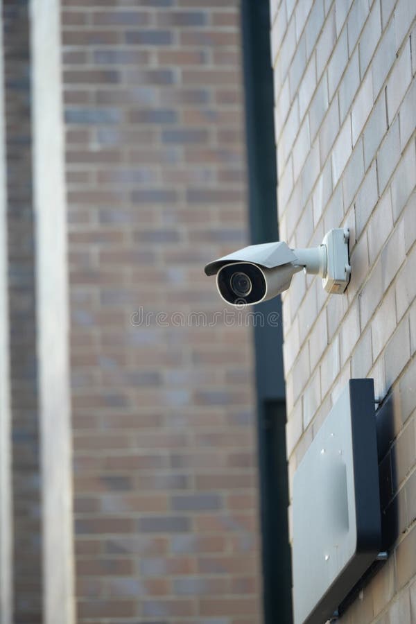 Security Camera Mounted on a Brick Wall beside an Entrance Stock Photo ...