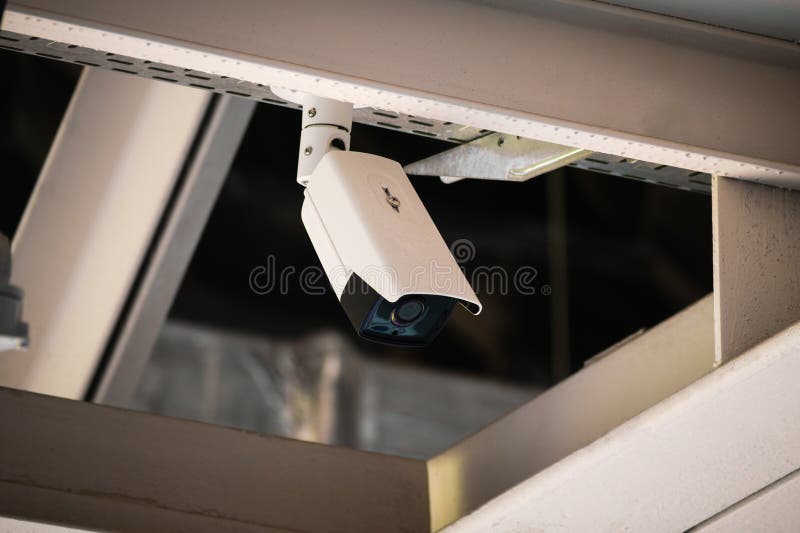A Security Camera Mounted on a Metal Beam Under the Ceiling Stock Photo ...