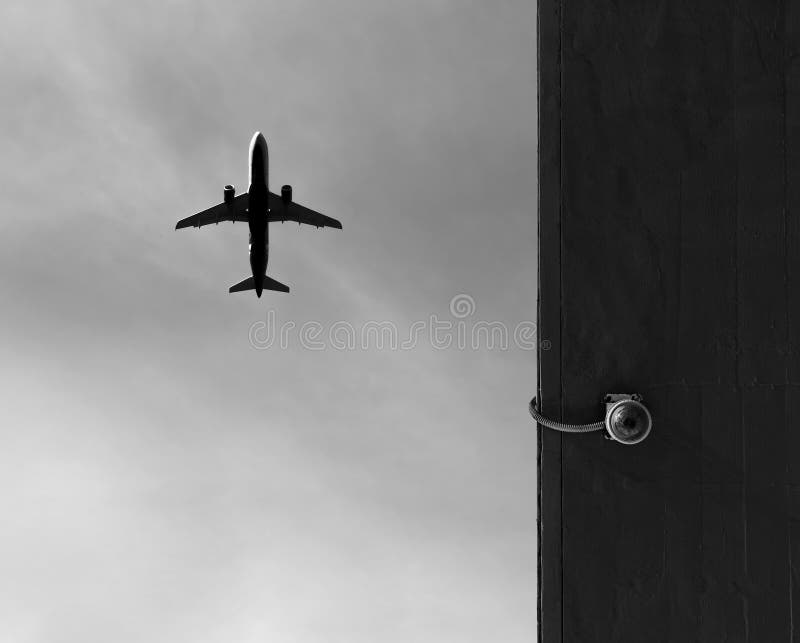 Security Camera Mounted on a Wall with a Plane Above Stock Image ...