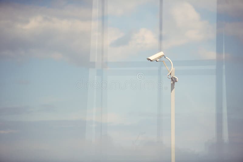 Security Camera on the Pole, View through the Glass with Reflections ...