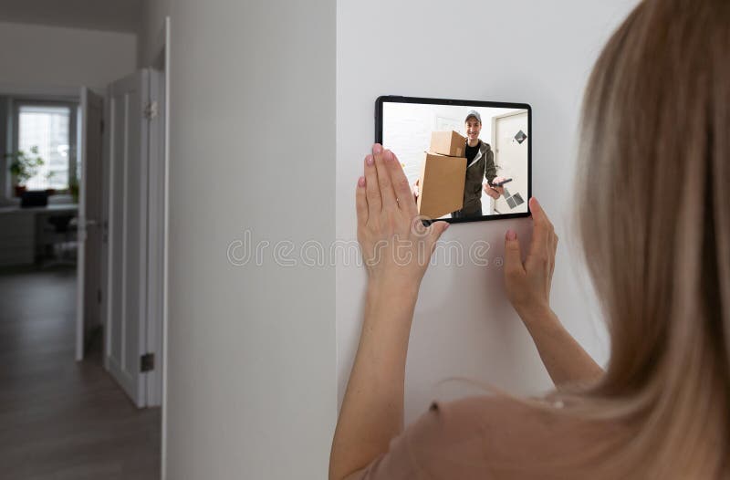 Security Camera System on Tablet App - Delivery Man Holding Package in ...