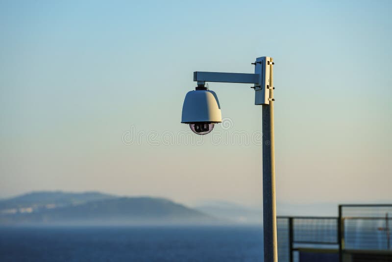 Security Camera on Top of a Mast Against Blue Sky Stock Photo - Image ...