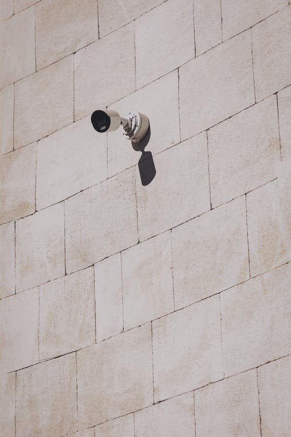 Security Camera on Wall of Modern Building. Surveillance Camera Mounted ...