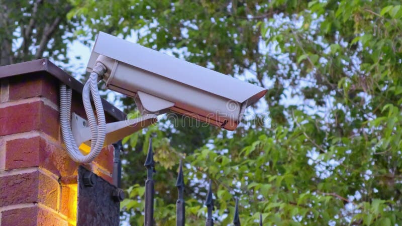 Security Camera on the Wall. Security Camera Scanning the Street in ...