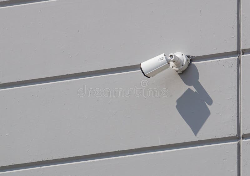 Security Camera Working on the Wall of a Building Stock Photo - Image ...