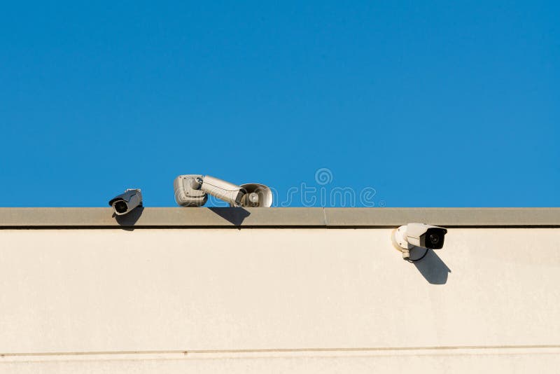 Security Cameras Mounted on a Building Under Clear Blue Sky Stock Image ...