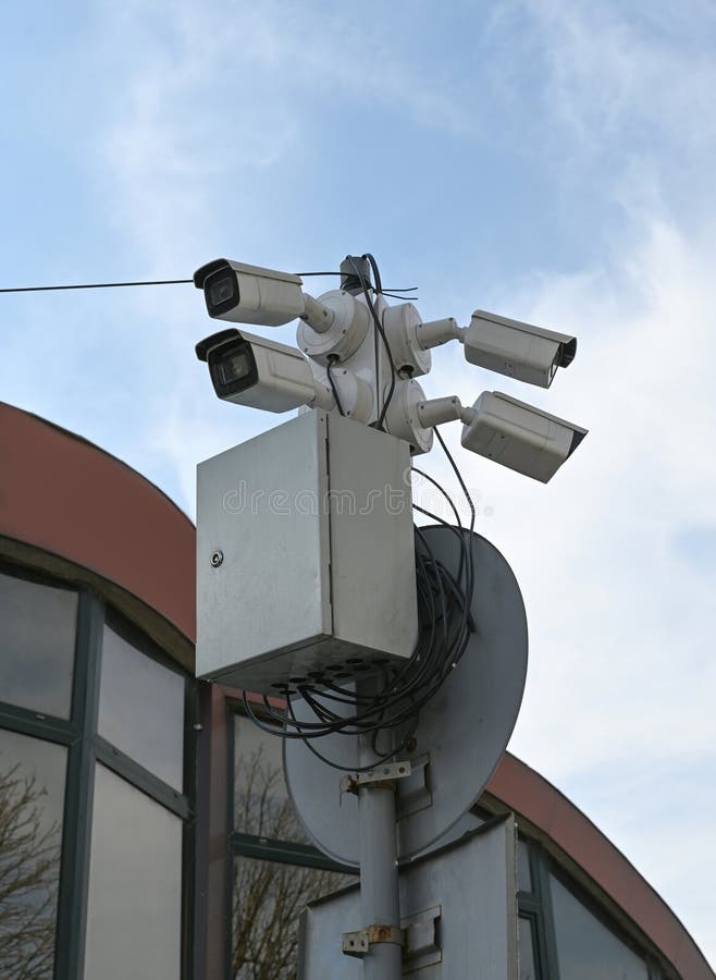 Security Cameras Mounted on a Pole Outside a Modern Building during a ...
