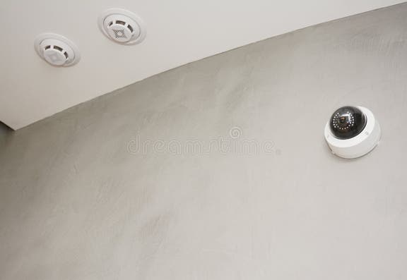 Security CCTV Camera is Mounted on the Room Wall with Fire Alarm System ...