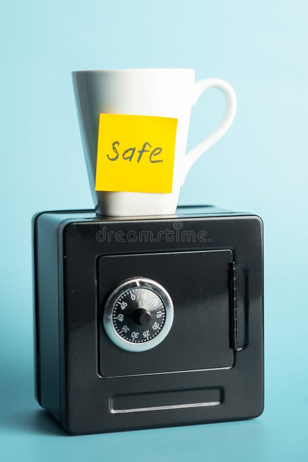 Security Concept: Cup Balanced on Safe with Sticky Note Stock Image ...