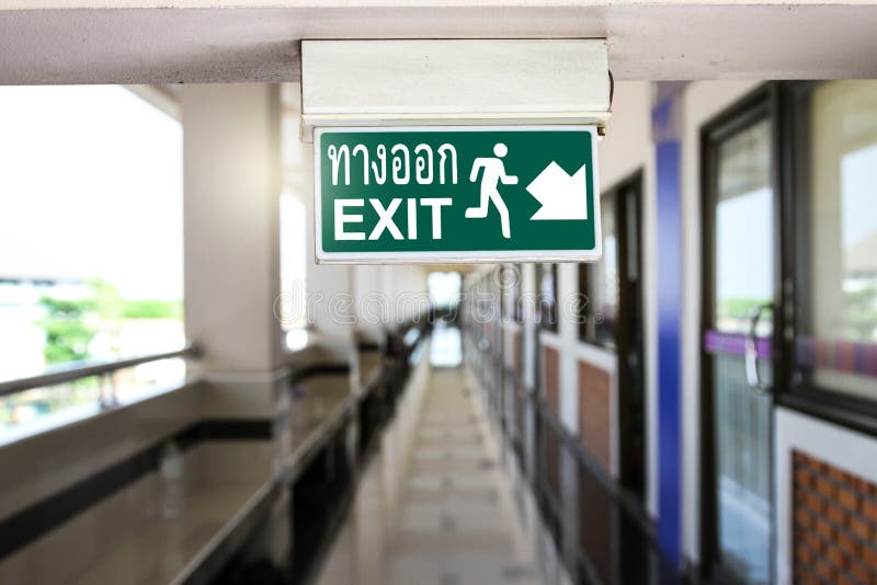 Green Emergency Fire Exit Sign in the Building. Stock Photo - Image of ...