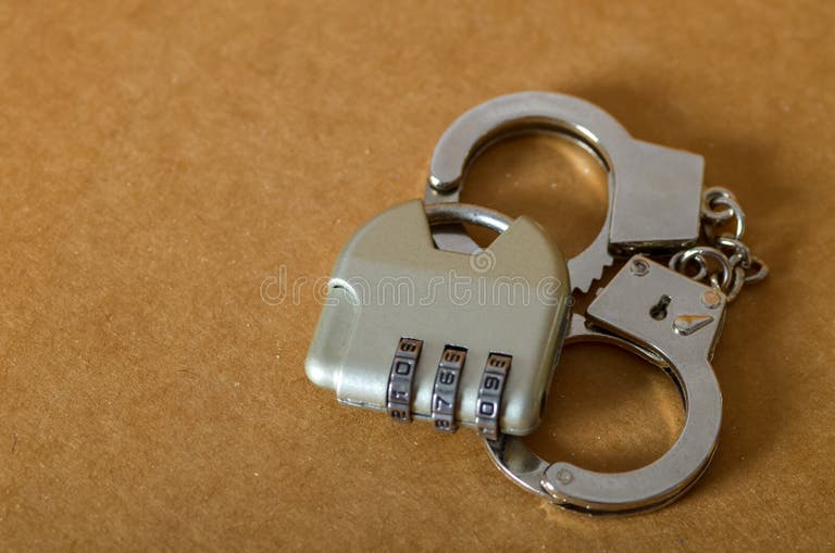 Security and Confinement: Handcuffs with Code Lock on Rough Background ...