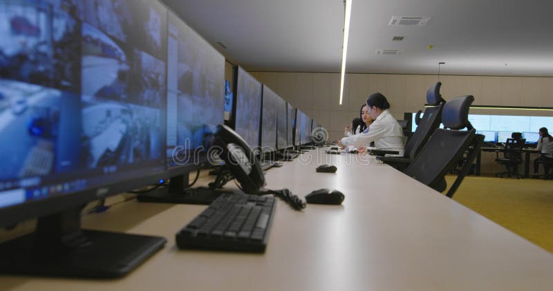 Security Guards Monitoring Modern CCTV Cameras in Surveillance Room ...