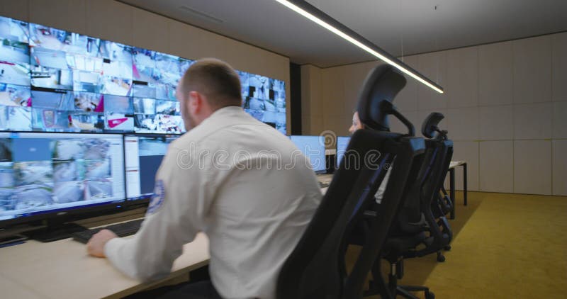 Security Guards Monitoring Modern CCTV Cameras in Surveillance Room ...