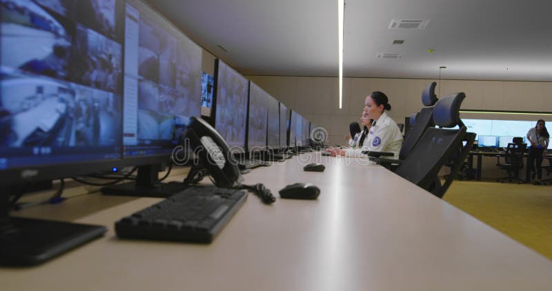 Security Guards Monitoring Modern CCTV Cameras in Surveillance Room ...