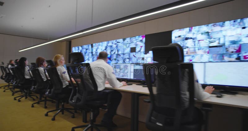 Security Guards Monitoring Modern CCTV Cameras in Surveillance Room ...