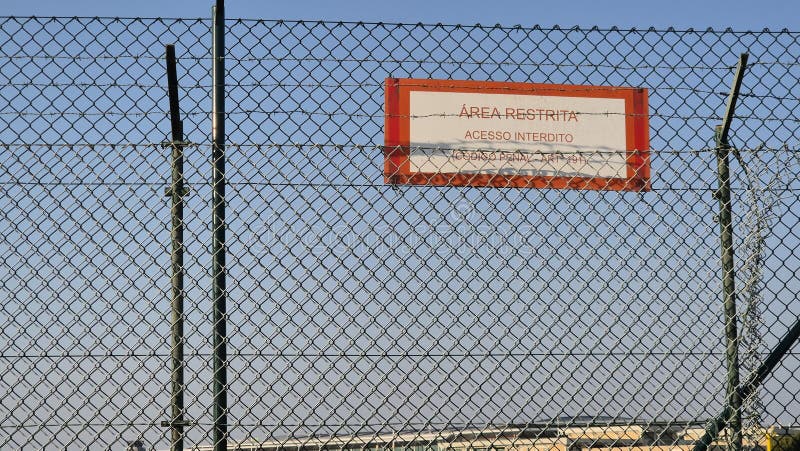A Security Fence with Barbed Wire Marks the Perimeter of a Restricted ...