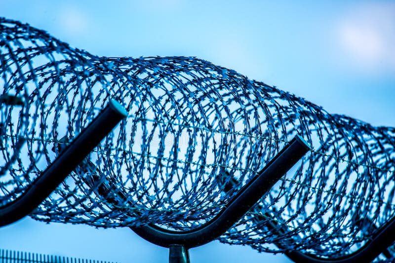 Security fence barbed wire stock photo. Image of design - 194389764