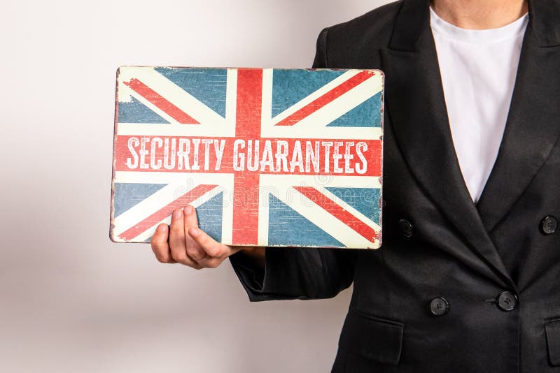 Security Guarantees Concept with British Flag and Businessman Holding ...