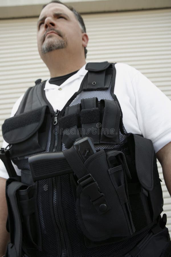 Security Guard in Bulletproof Vest Holding Gun Stock Image - Image of ...