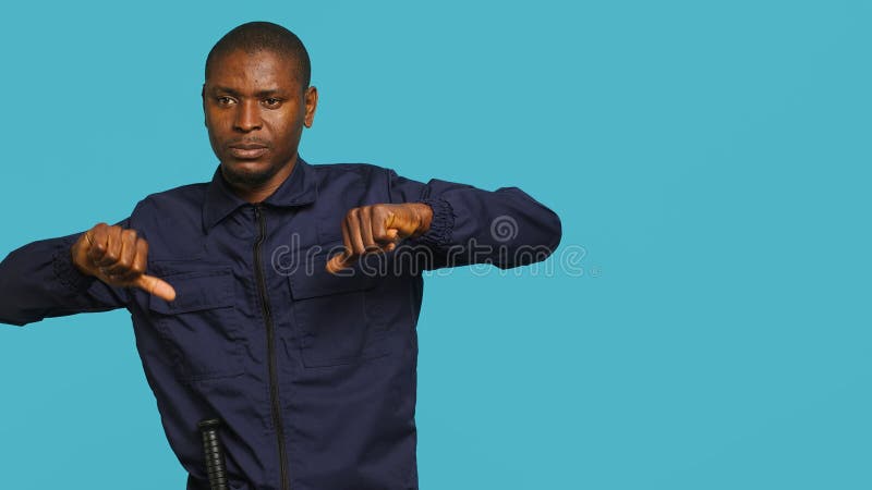 Portrait of Bodyguard Doing Thumbs Down Hand Gesture, Being Dismissive ...