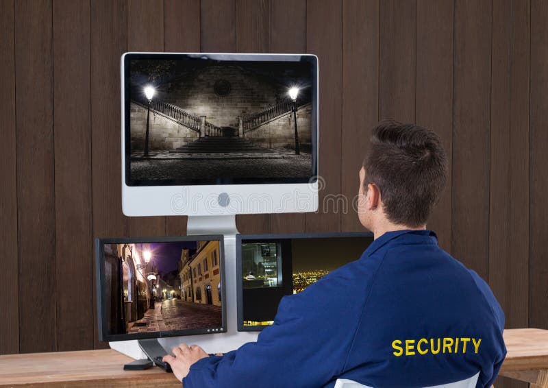 Security Guard Looking the Images of the Security Cameras on the ...