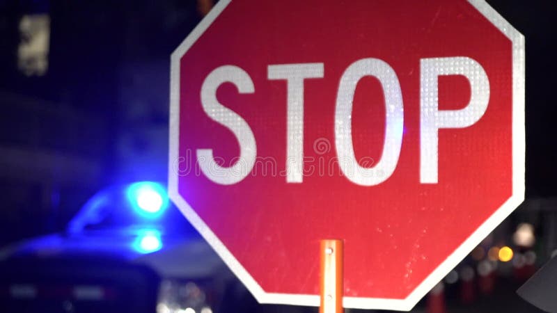 Security Guard Holding Stop Slow Down Sign at Night Construction Site ...